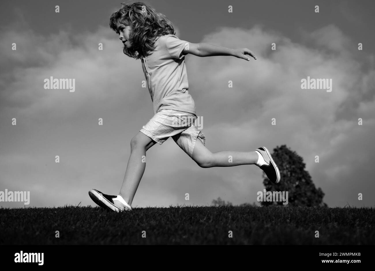 Child fun run outdoors. Kid playing in summer park. Little boy running ...