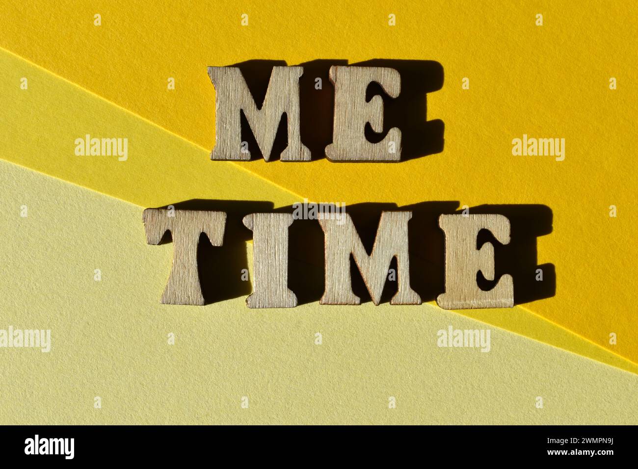 Me Time, words in wooden alphabet letters isolated on yellow background ...