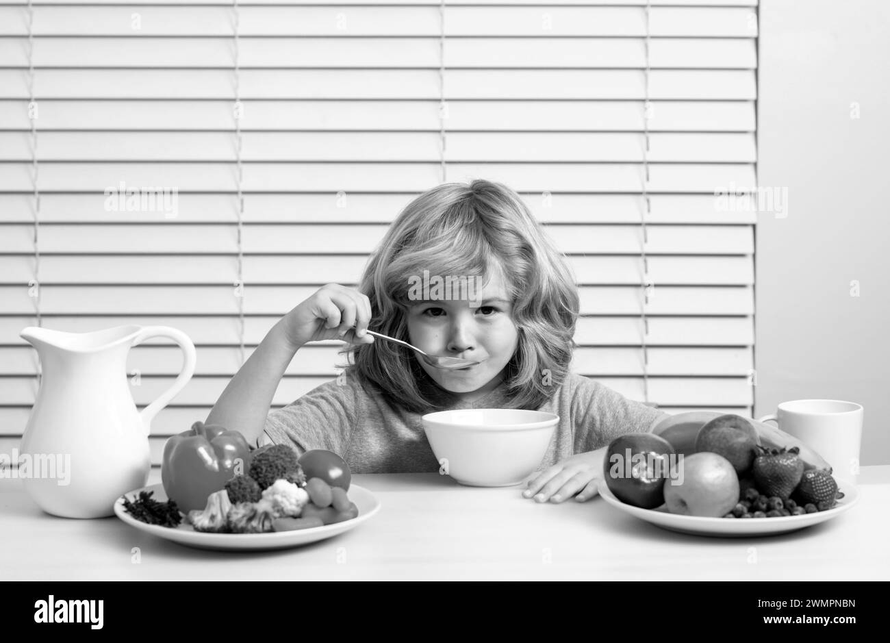 Morning snack with muesli cereal granola. Portrait of child eat fresh ...