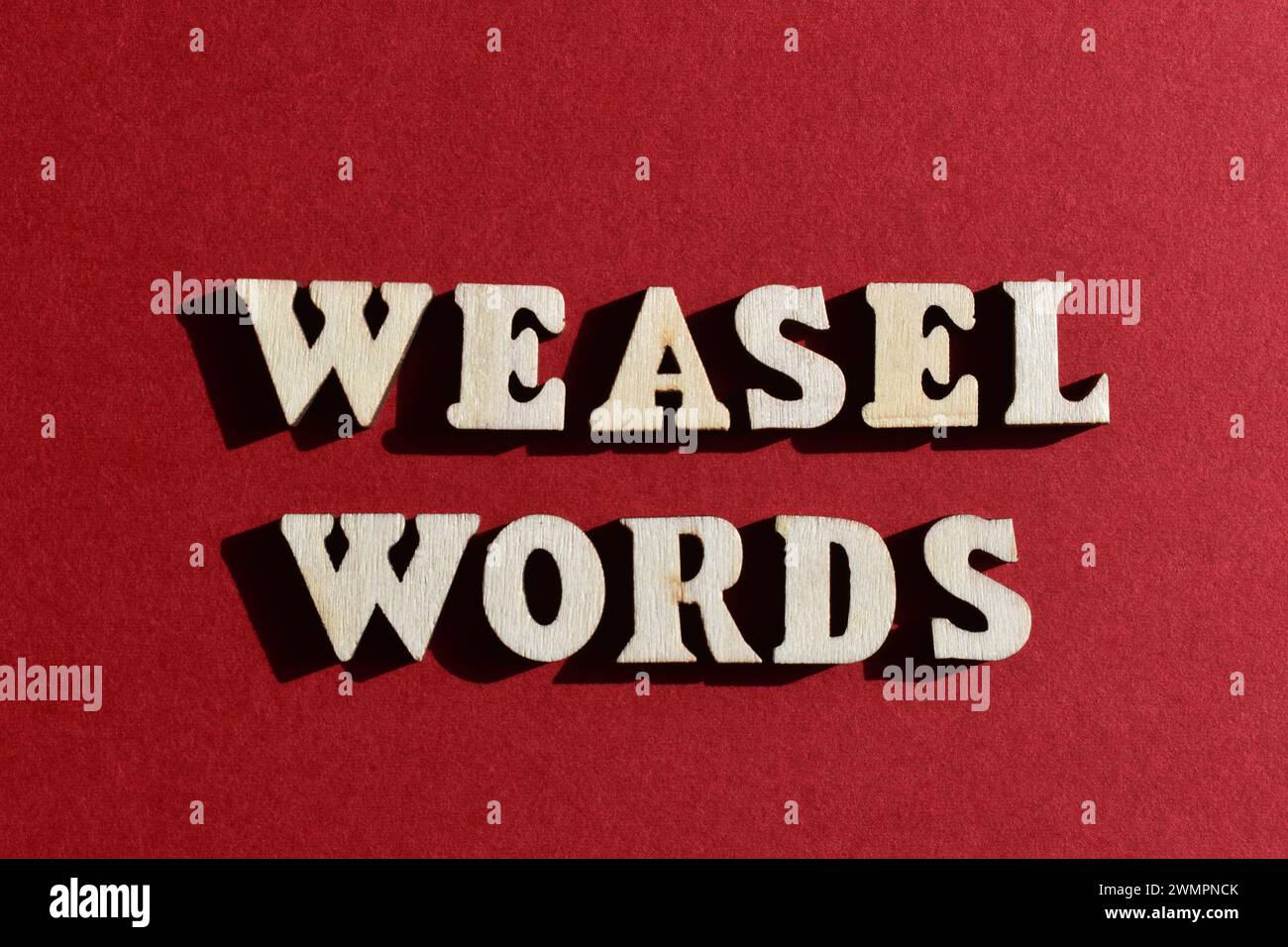 Weasel Words, phrase in wooden alphabet letters isolated on red ...