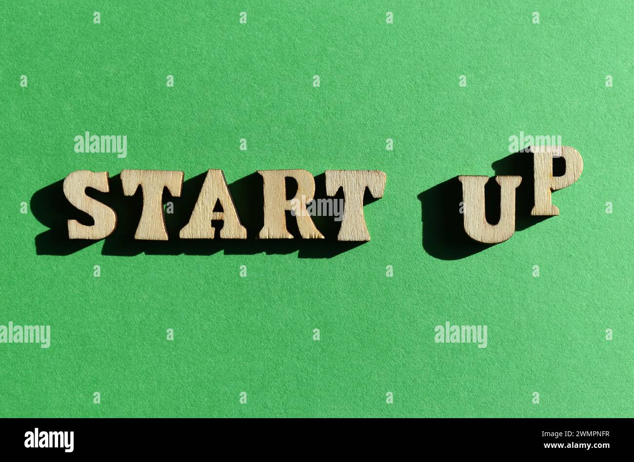 Start Up, words in wooden alphabet letters isolated on green background ...