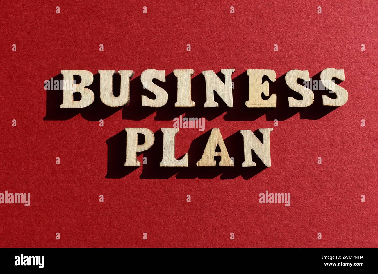 Business Plan, words in wooden alphabet letters isolated on red ...