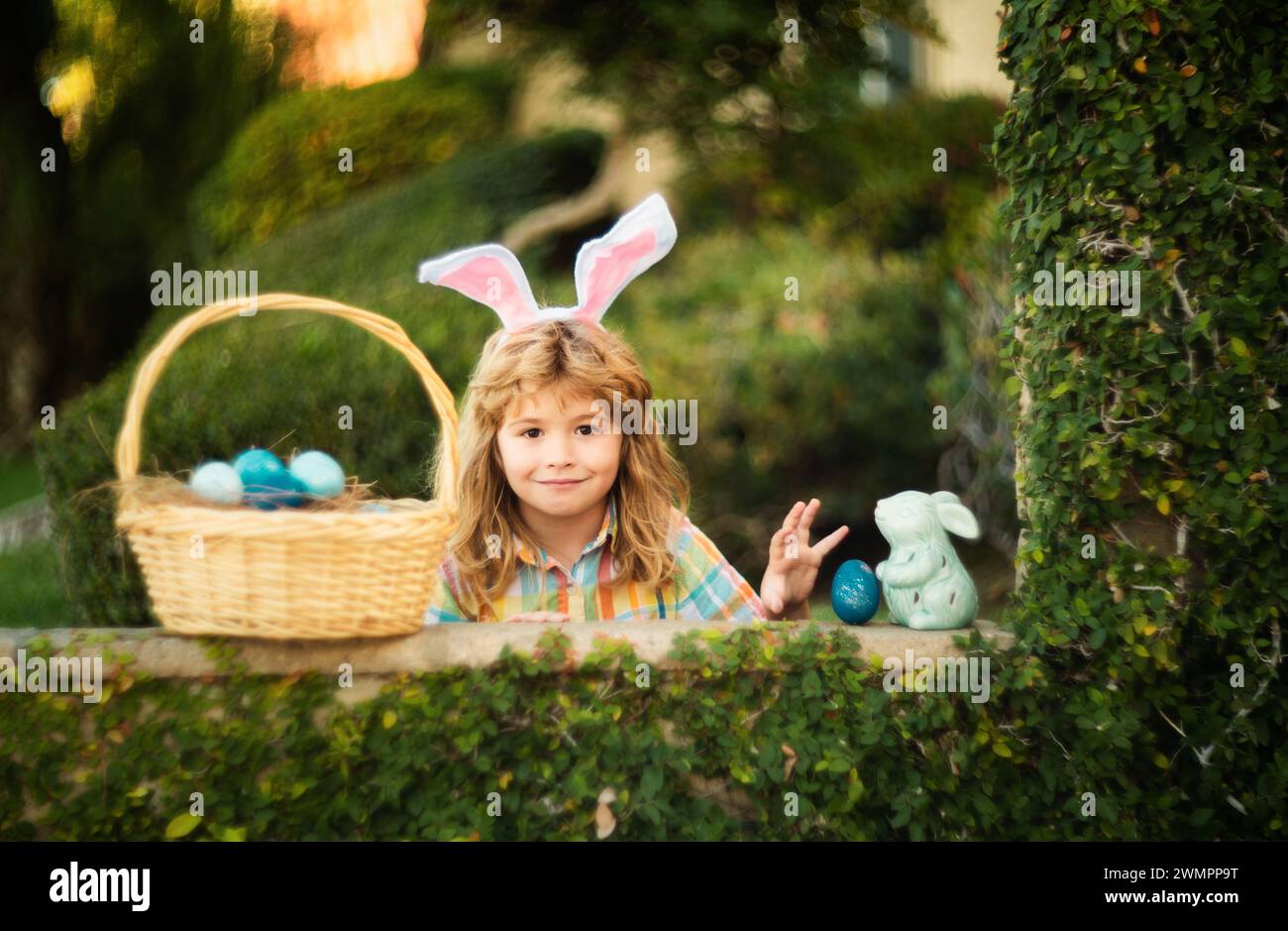 Easter bunny child hunting eggs with easters basket outdoors on Happy ...