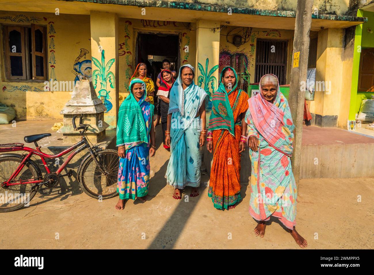 A group of traditionally dressed women in a Rural village in Odisha ...