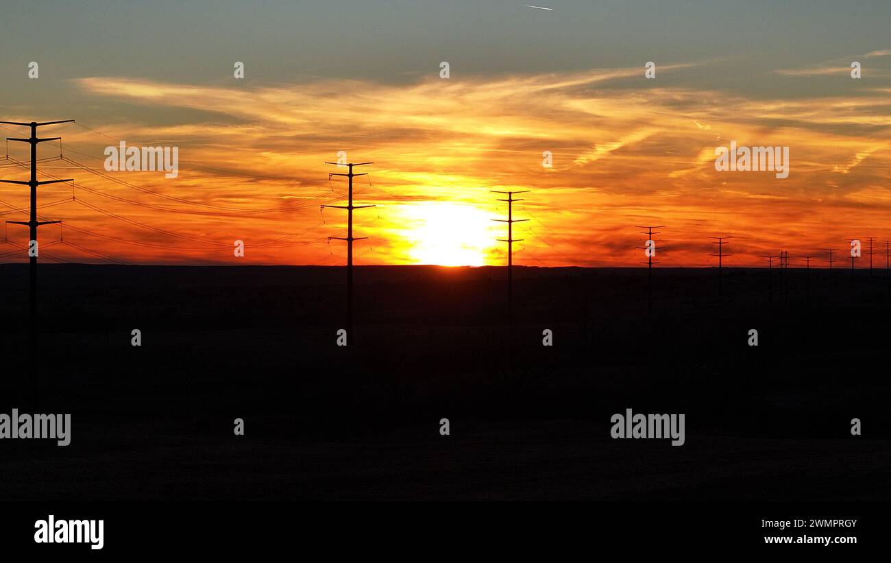Sunrise over rural field with telephone poles Stock Photo - Alamy
