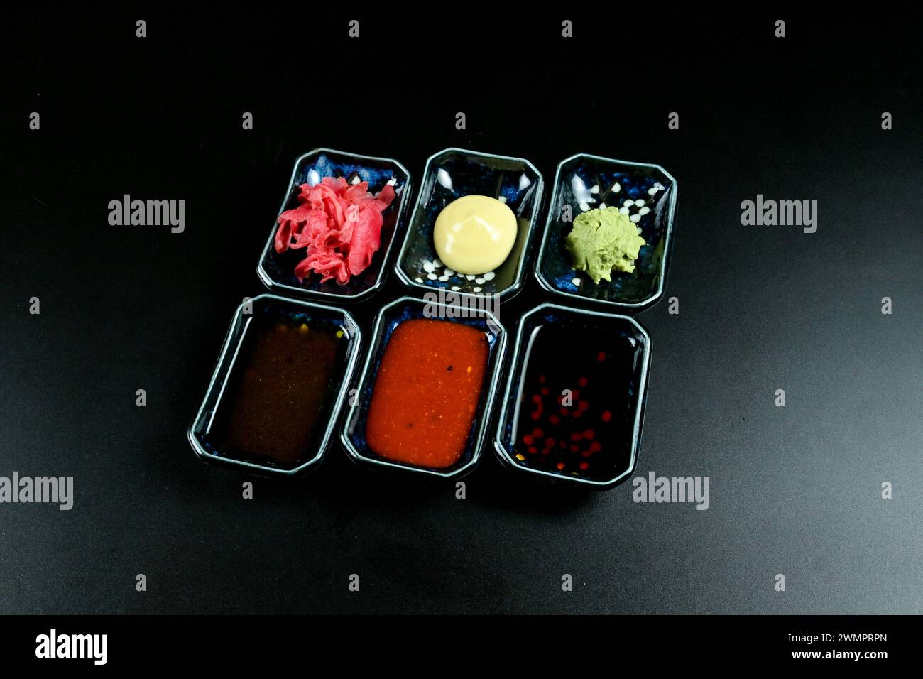 A table set with a tray and various small containers of sauces Stock ...