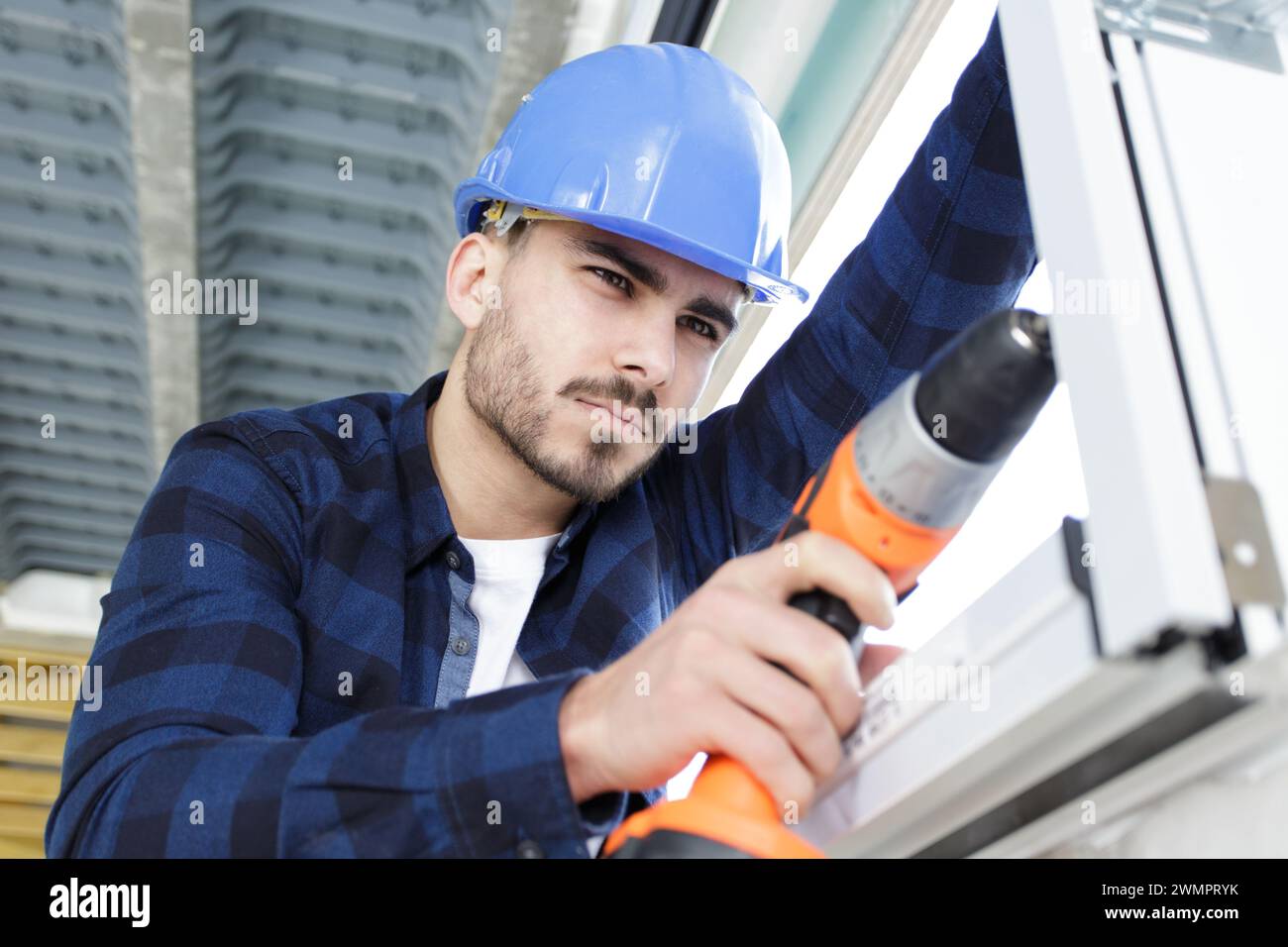 Young man using drill machine hi-res stock photography and images - Alamy