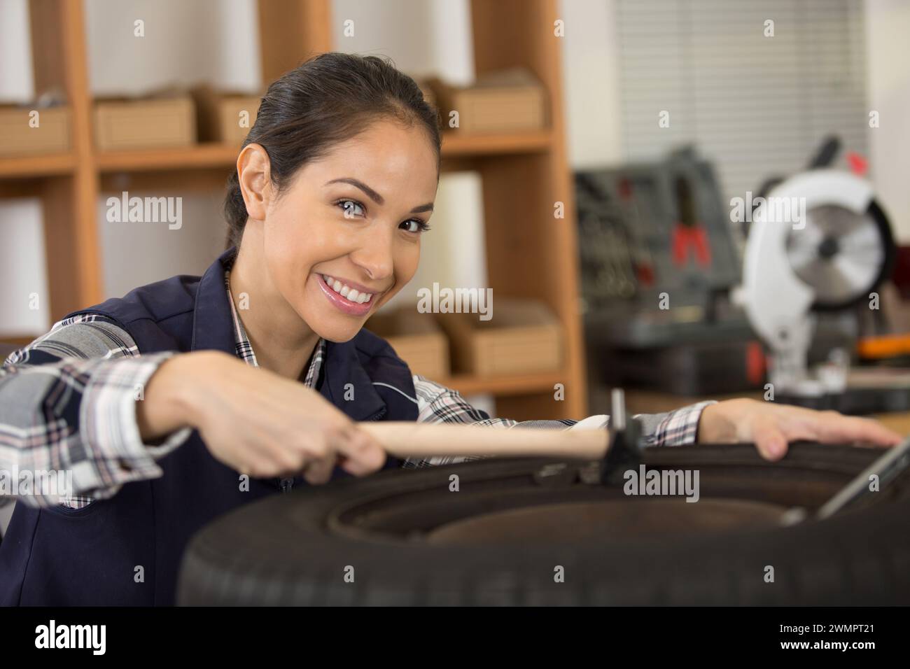 woman using a hammer to tap wheel Stock Photo - Alamy