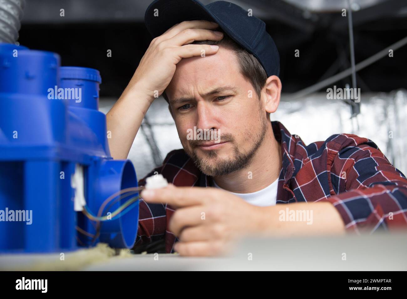 skilled worker having problems while replacing defective pipe Stock ...