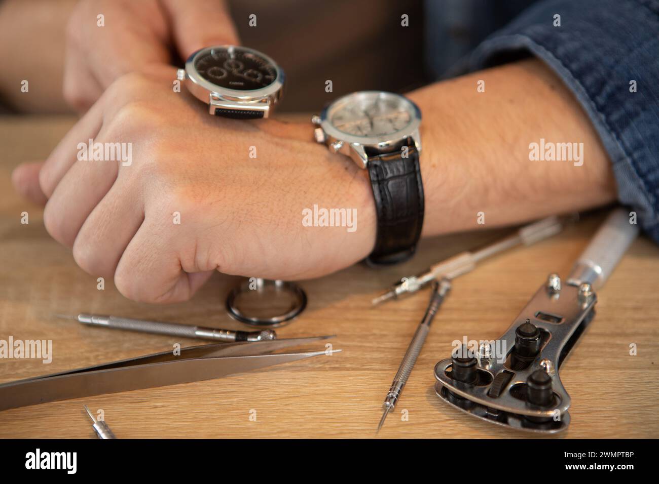 patient man repairing a watch cecking time Stock Photo - Alamy