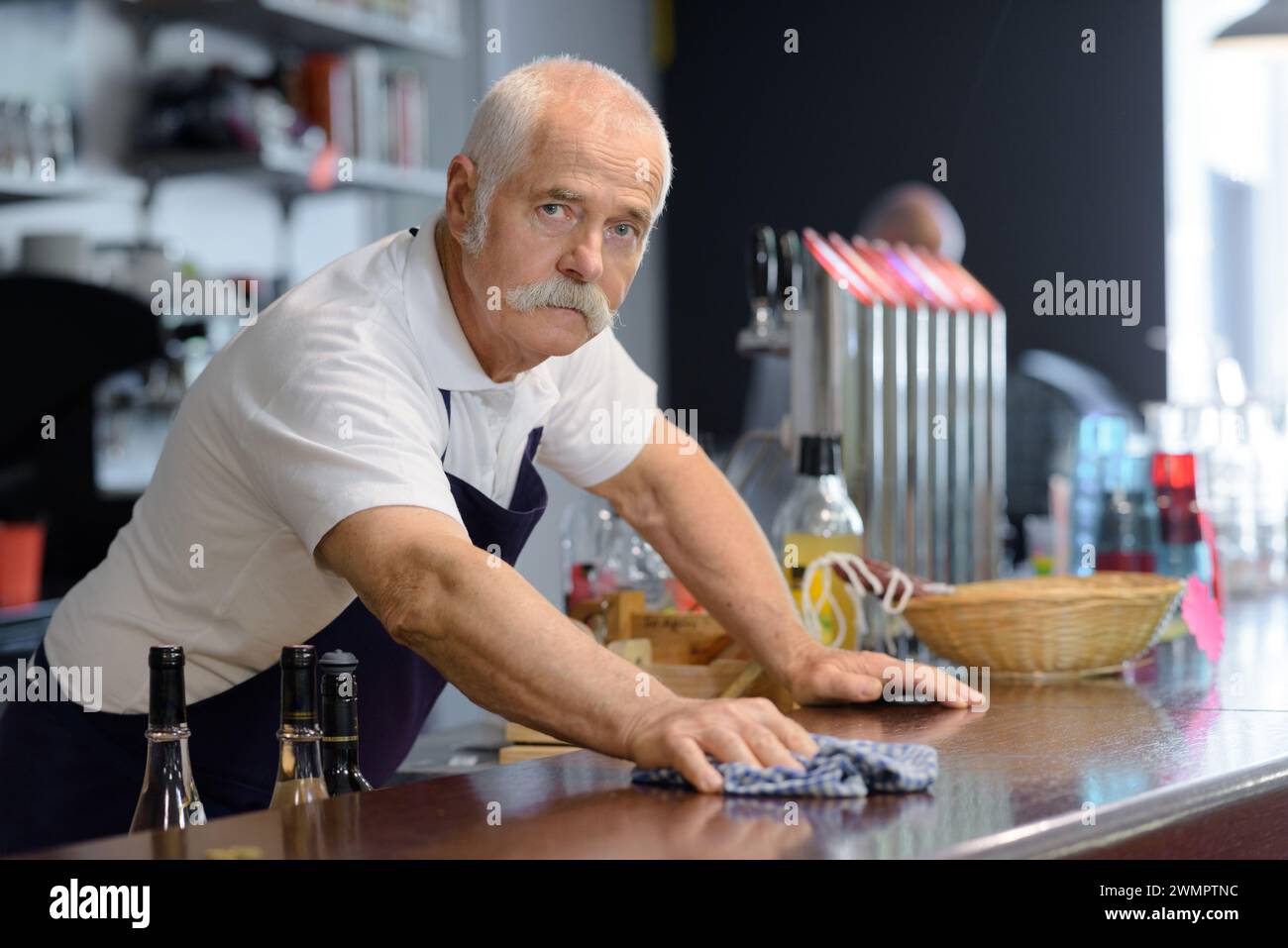 bartender cleaning bar counter Stock Photo - Alamy