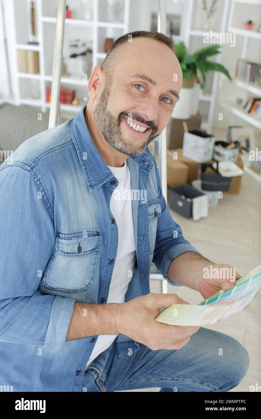 man choosing the perfect paint color Stock Photo - Alamy