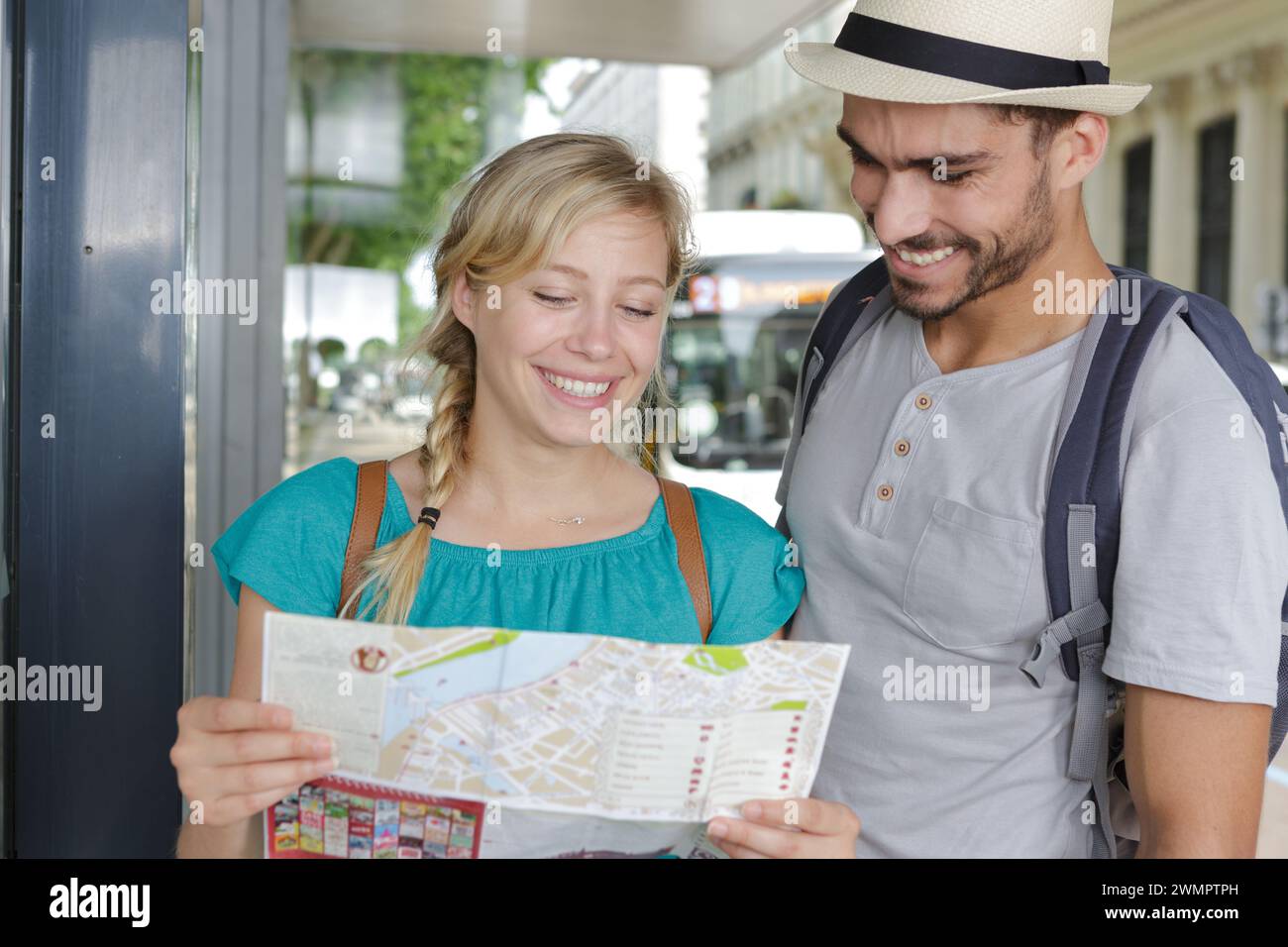 happy tourists looking with happy expression in map Stock Photo - Alamy