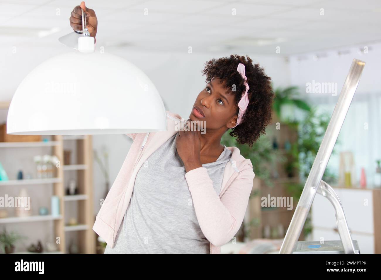 Woman placing lamp hi-res stock photography and images - Alamy