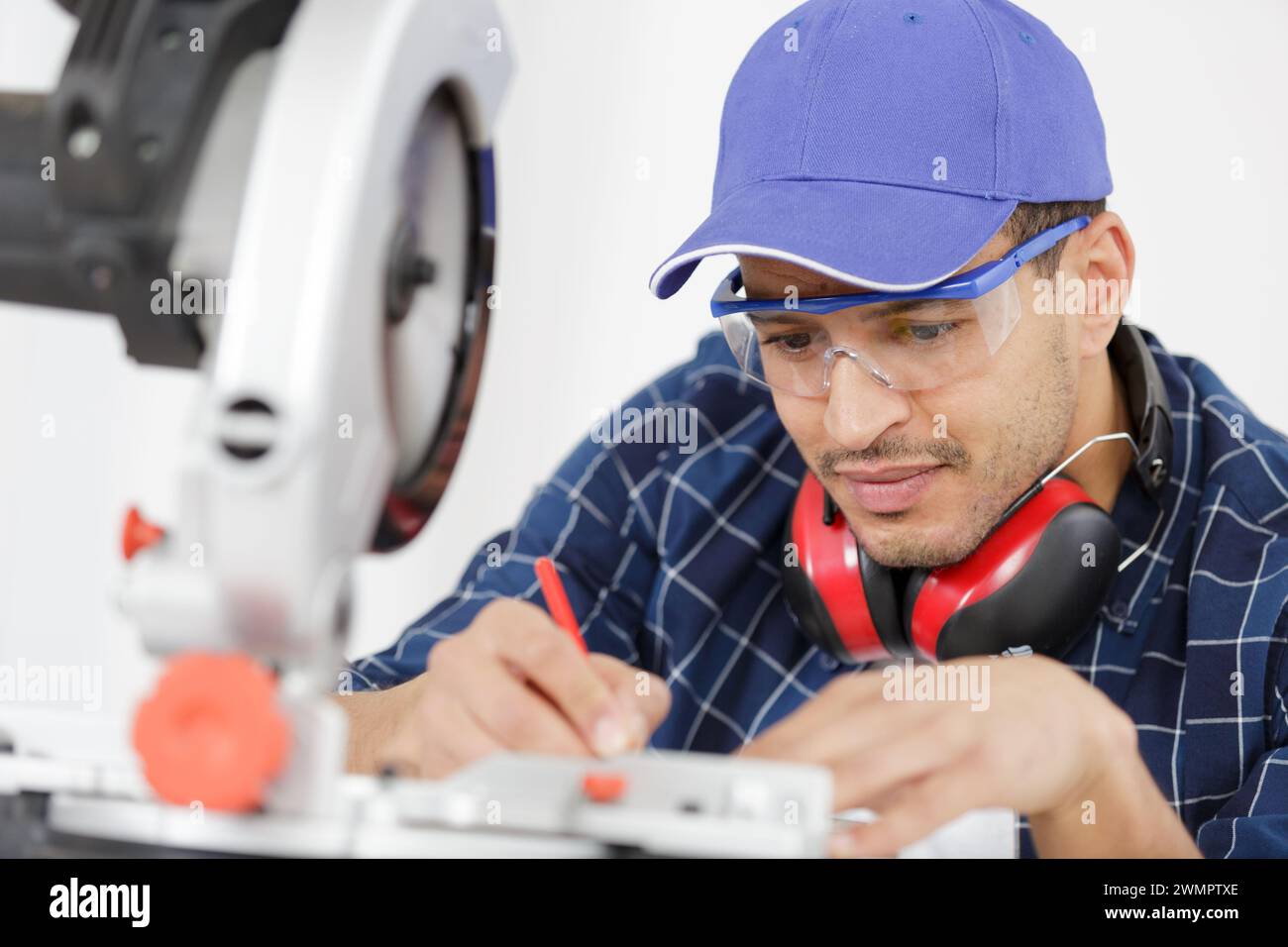 workman cutting wooden planks using circular saw in workshop Stock ...