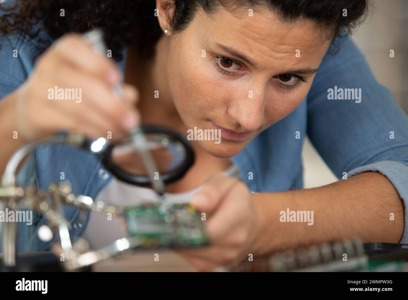 Woman soldering elements circuit hi-res stock photography and images ...