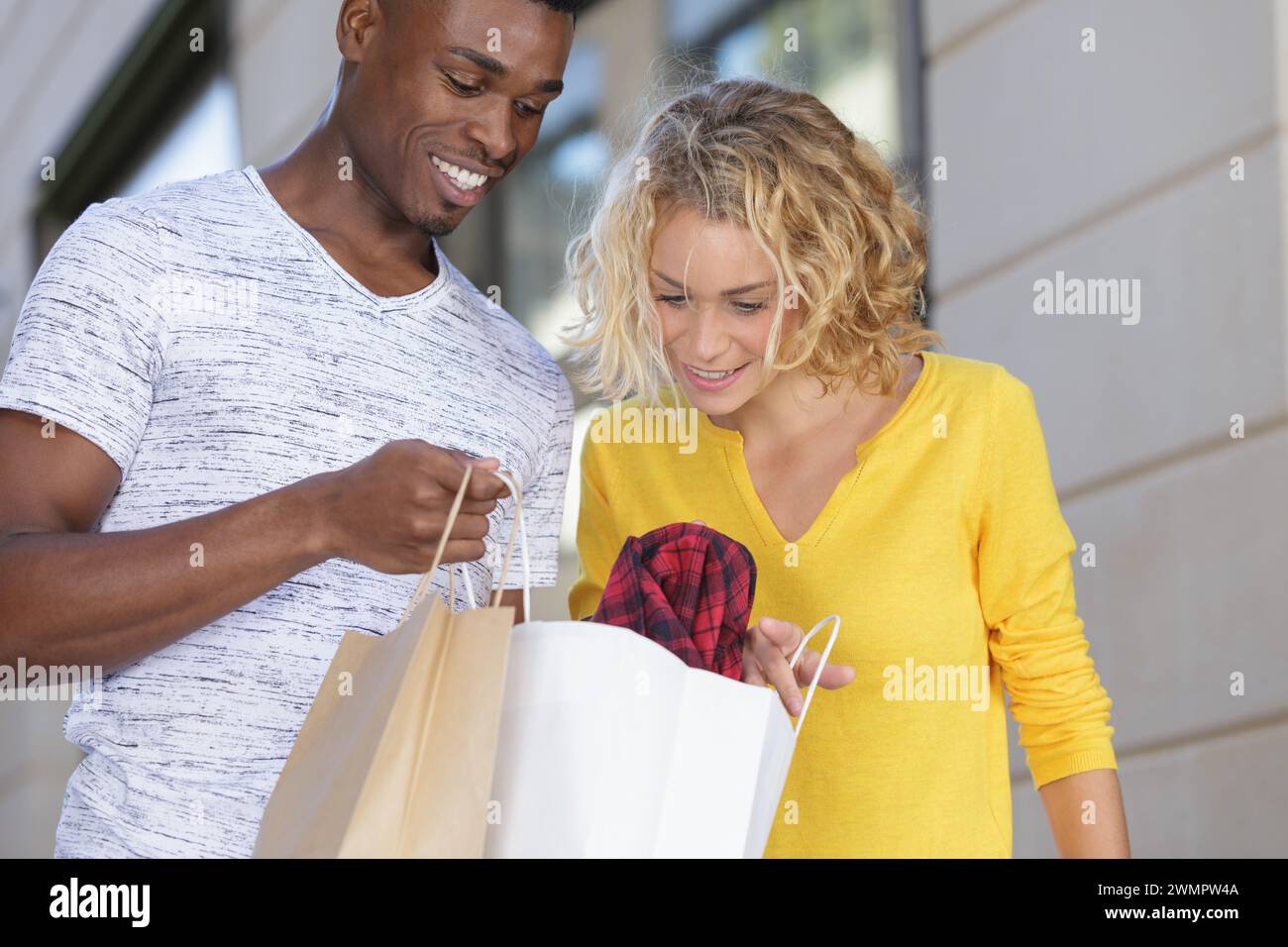 couples showing eachother what they bought Stock Photo - Alamy