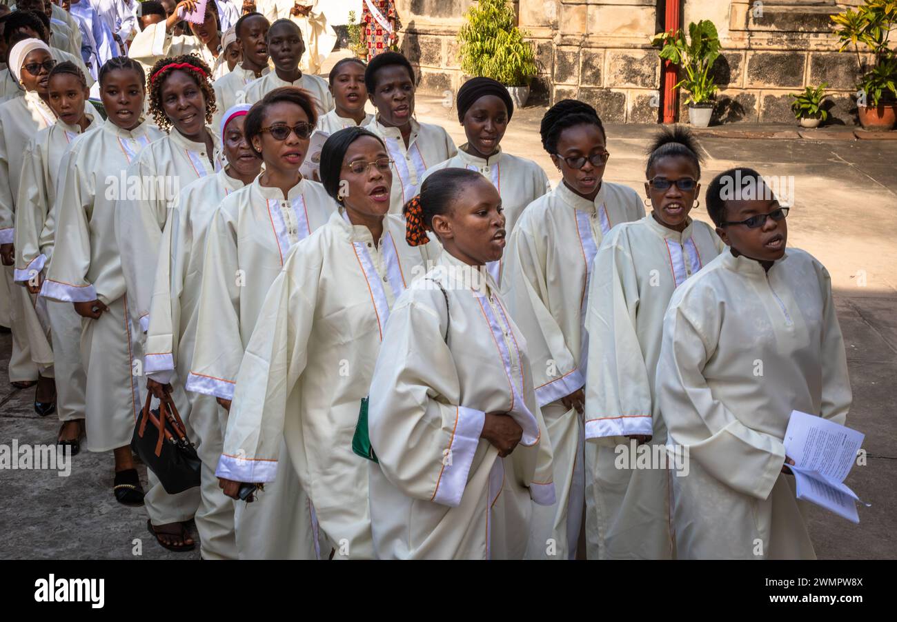 Dressed in white, the choir sings as it enters St Joseph's Cathedral ...