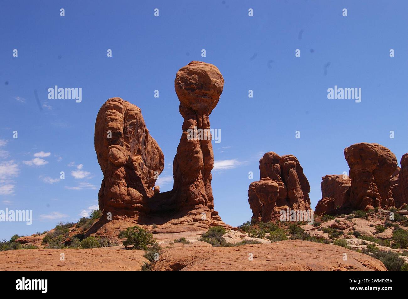 A red rocky outcrop beside a parched desert landscape in Utah Stock ...