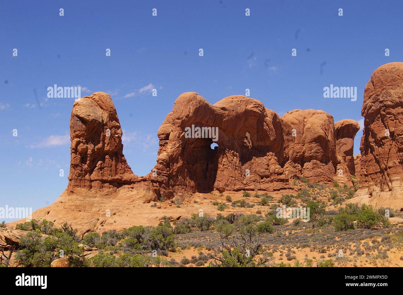 A red rocky outcrop beside a parched desert landscape in Utah Stock ...