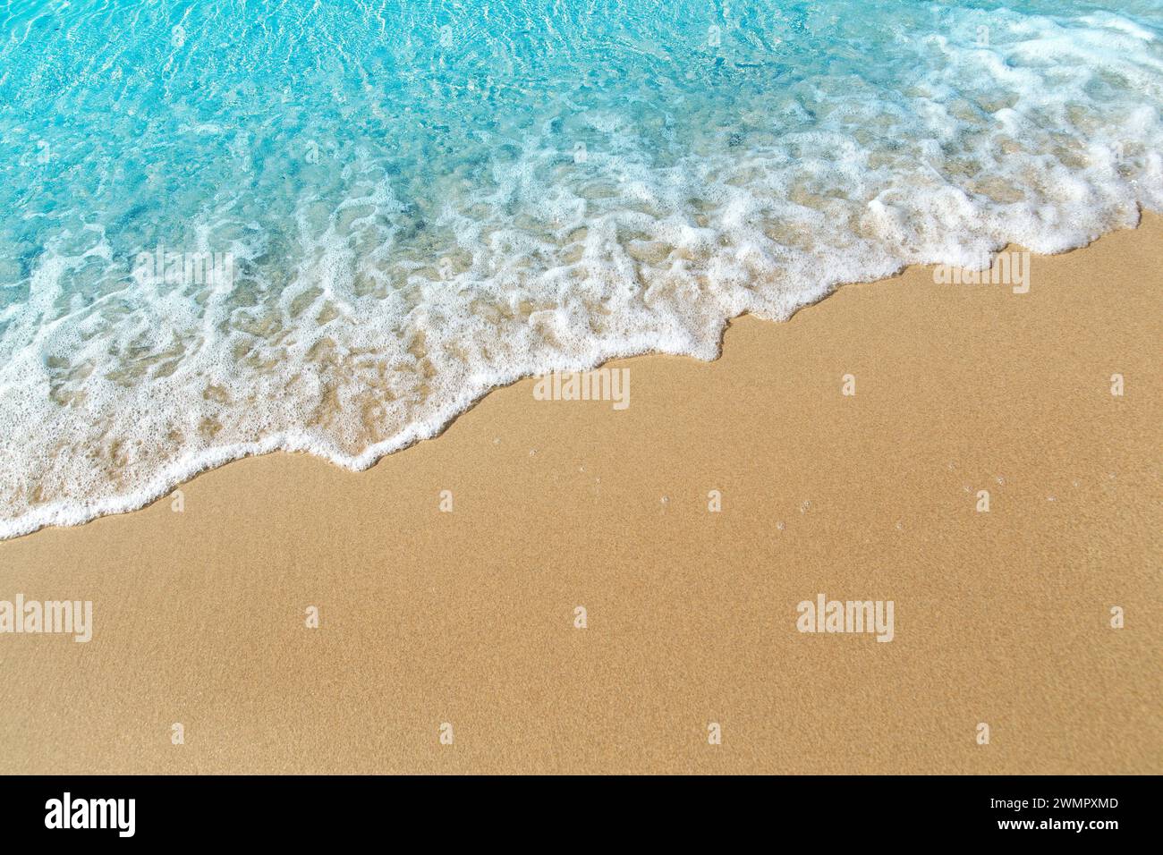 Sea wave on beach sand Stock Photo - Alamy
