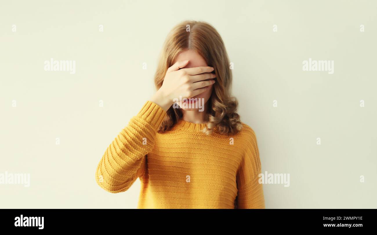 Upset sad young woman keeps hand palm on face, regrets or sorrow ...