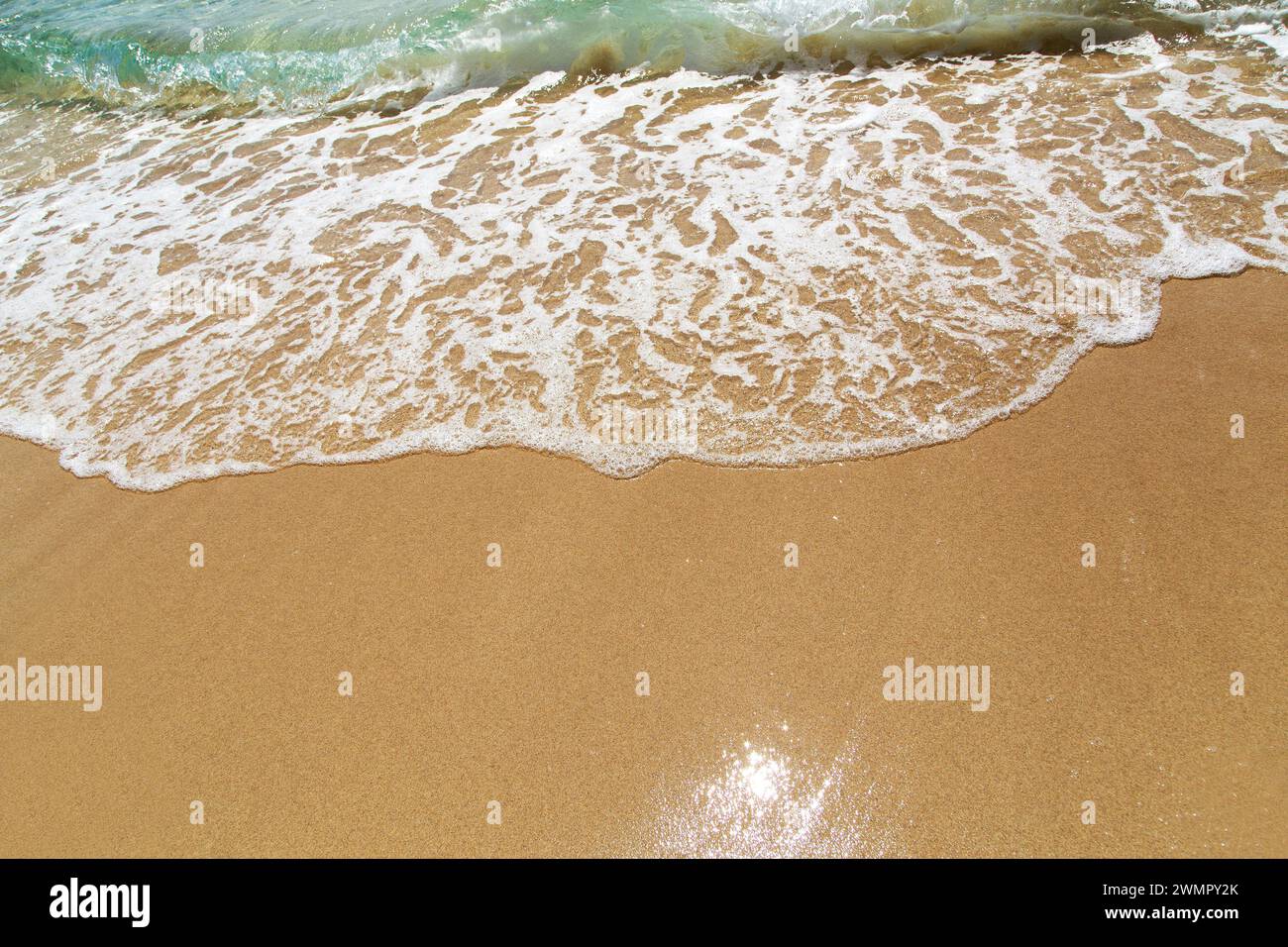 Sea wave on beach sand Stock Photo - Alamy