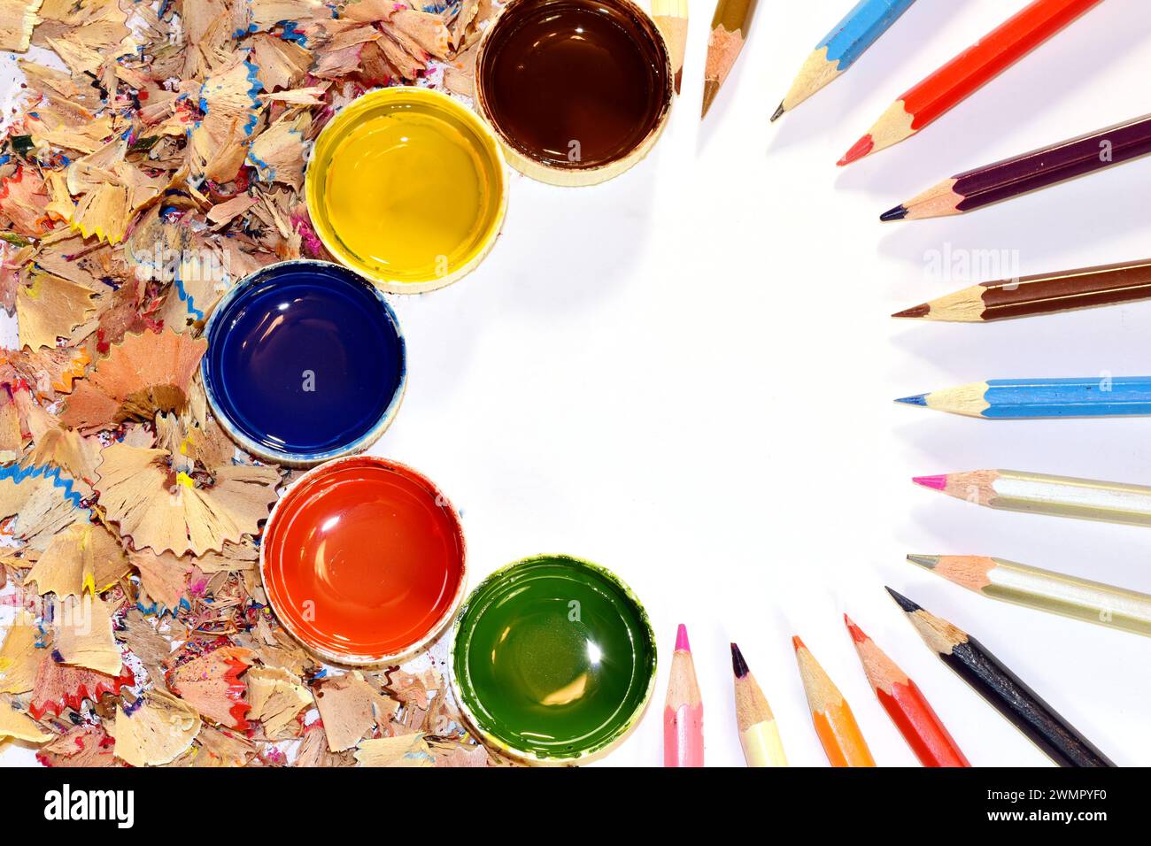 On the table lie sharpened colored pencils, wood shavings from them ...