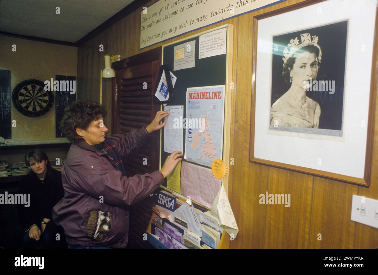 Local woman Robbie MacKenzie putting up a Russian language notice for a ...