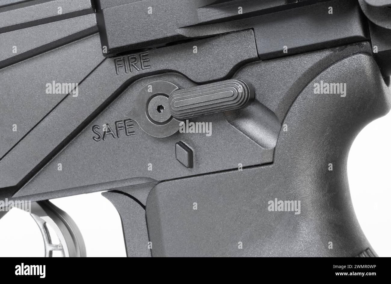 Safety lever on safe on a rifle with trigger visible on a white ...