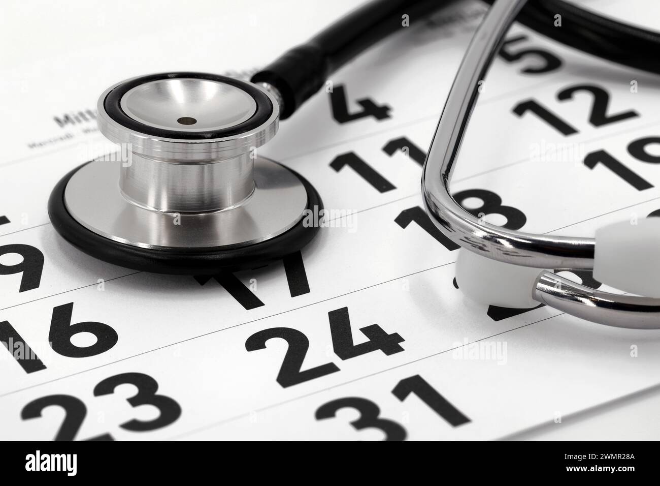 black stethoscope on calendar page, concept for scheduling a doctor's appointment or annual ...