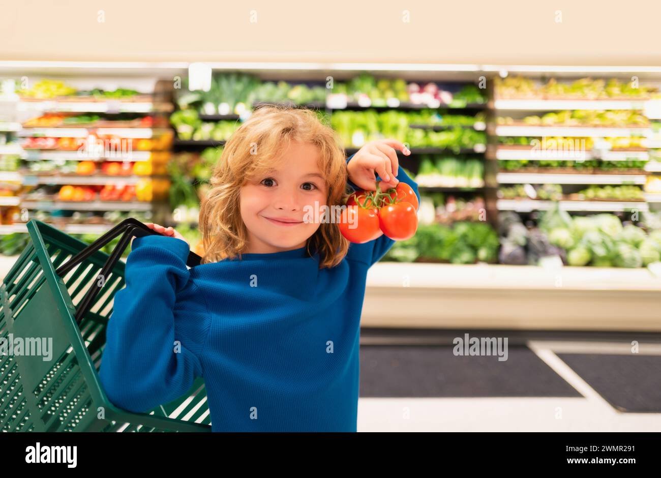 Child with fresh tomato vegetables. Shopping in supermarket. Kids ...