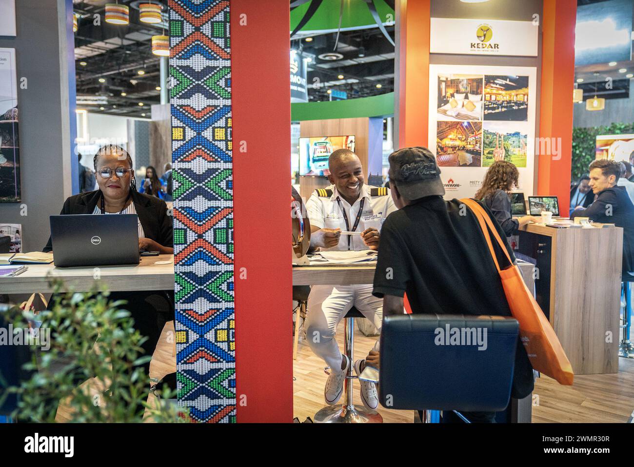 Johannesburg, South Africa. 27th Feb, 2024. Exhibitors talk with ...