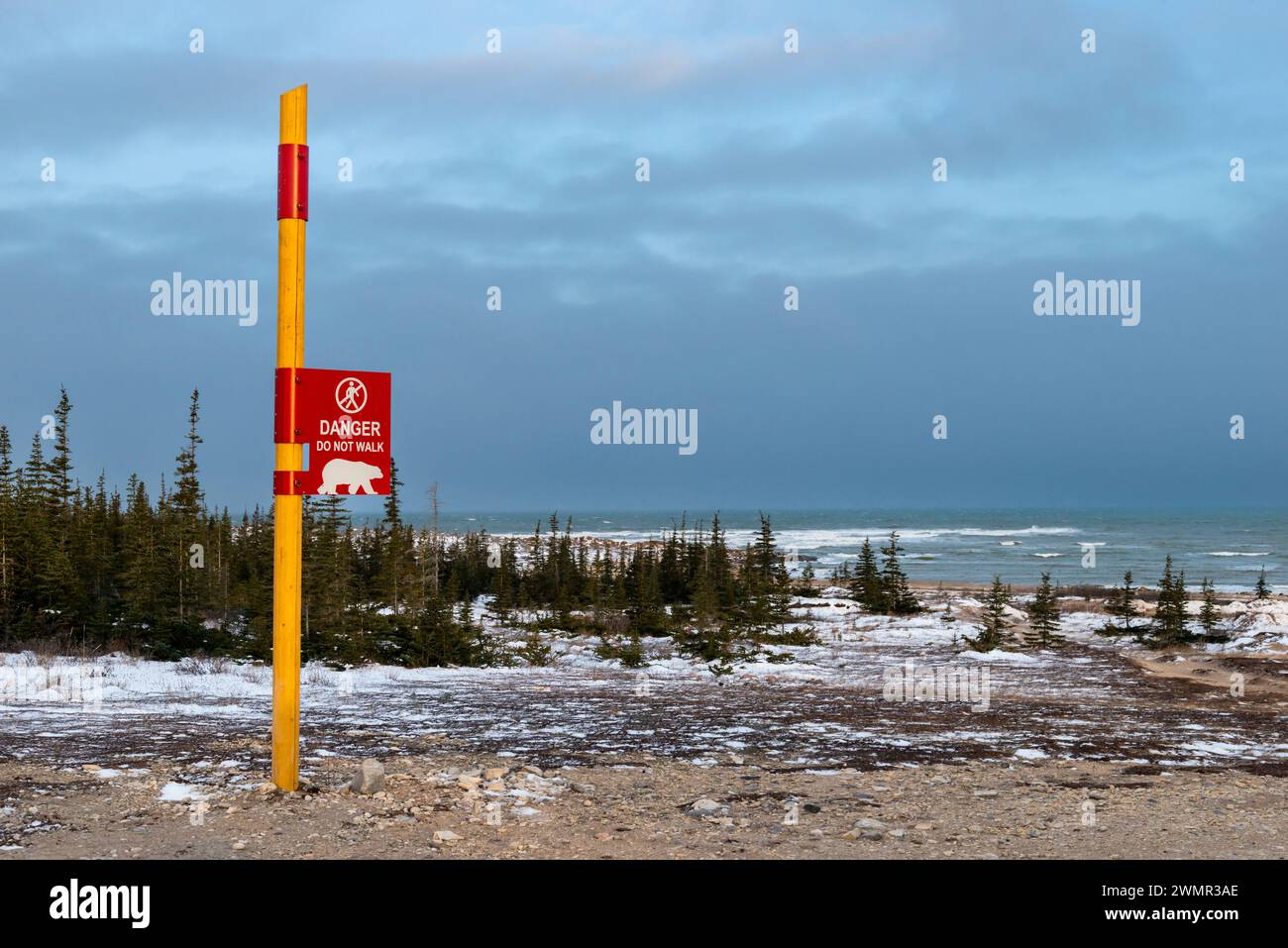 A bright red and yellow sign warns visitors to watch for polar bears in ...