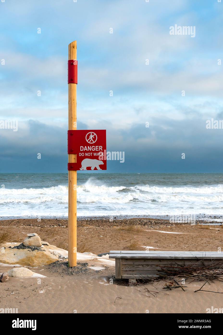 A red and yellow sign on the beach warns visitors to watch for polar ...