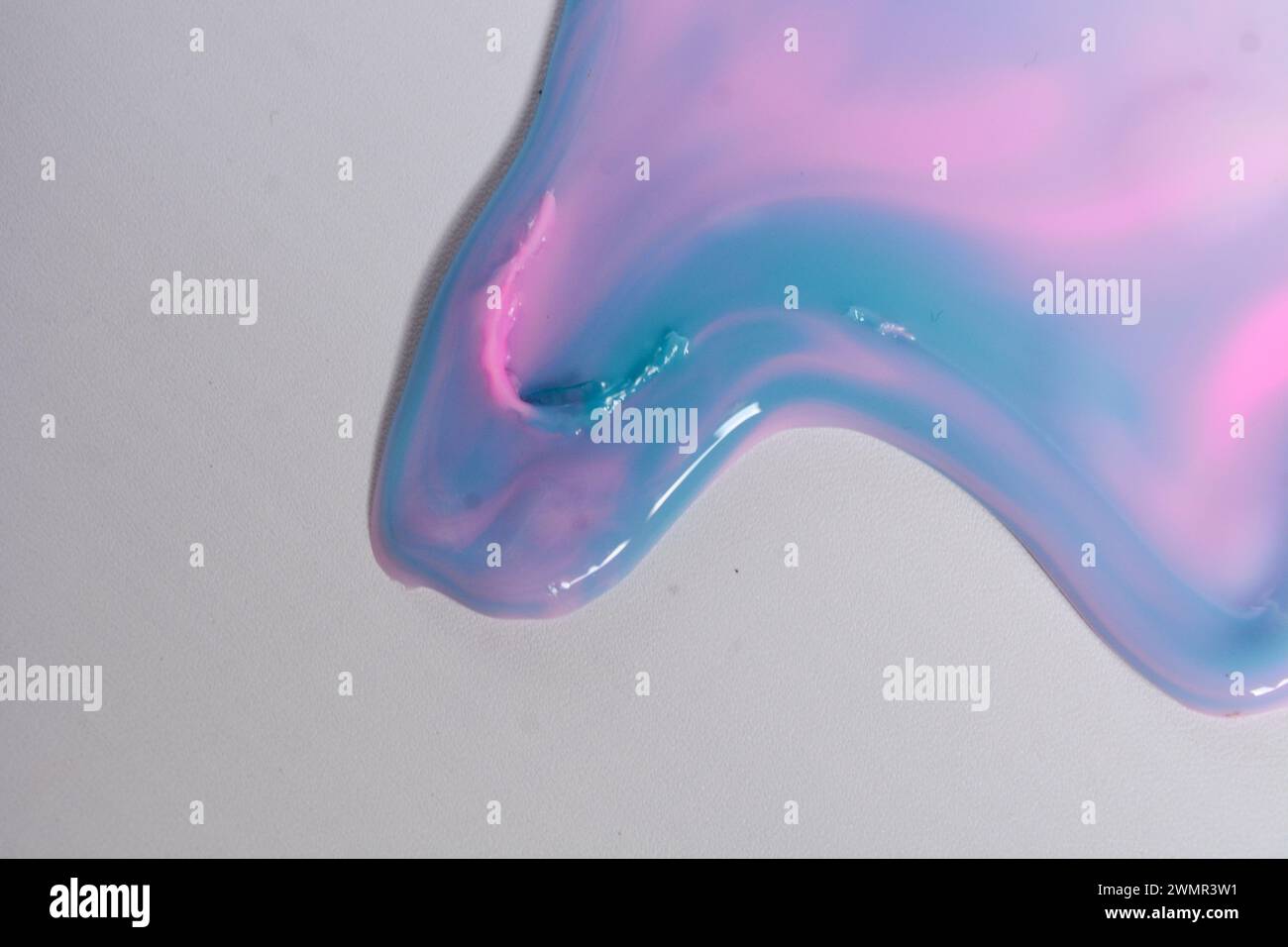 Colorful leaking paint liquid spills from close range Stock Photo - Alamy