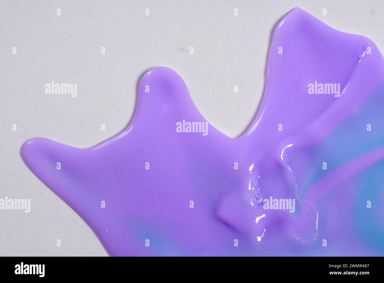Colorful leaking paint liquid spills from close range Stock Photo - Alamy