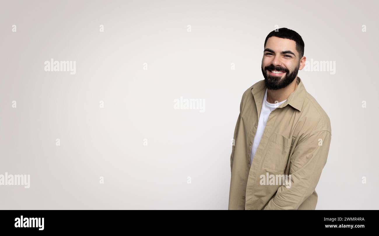 A jovial man with a beard and a wide smile leans slightly towards the ...