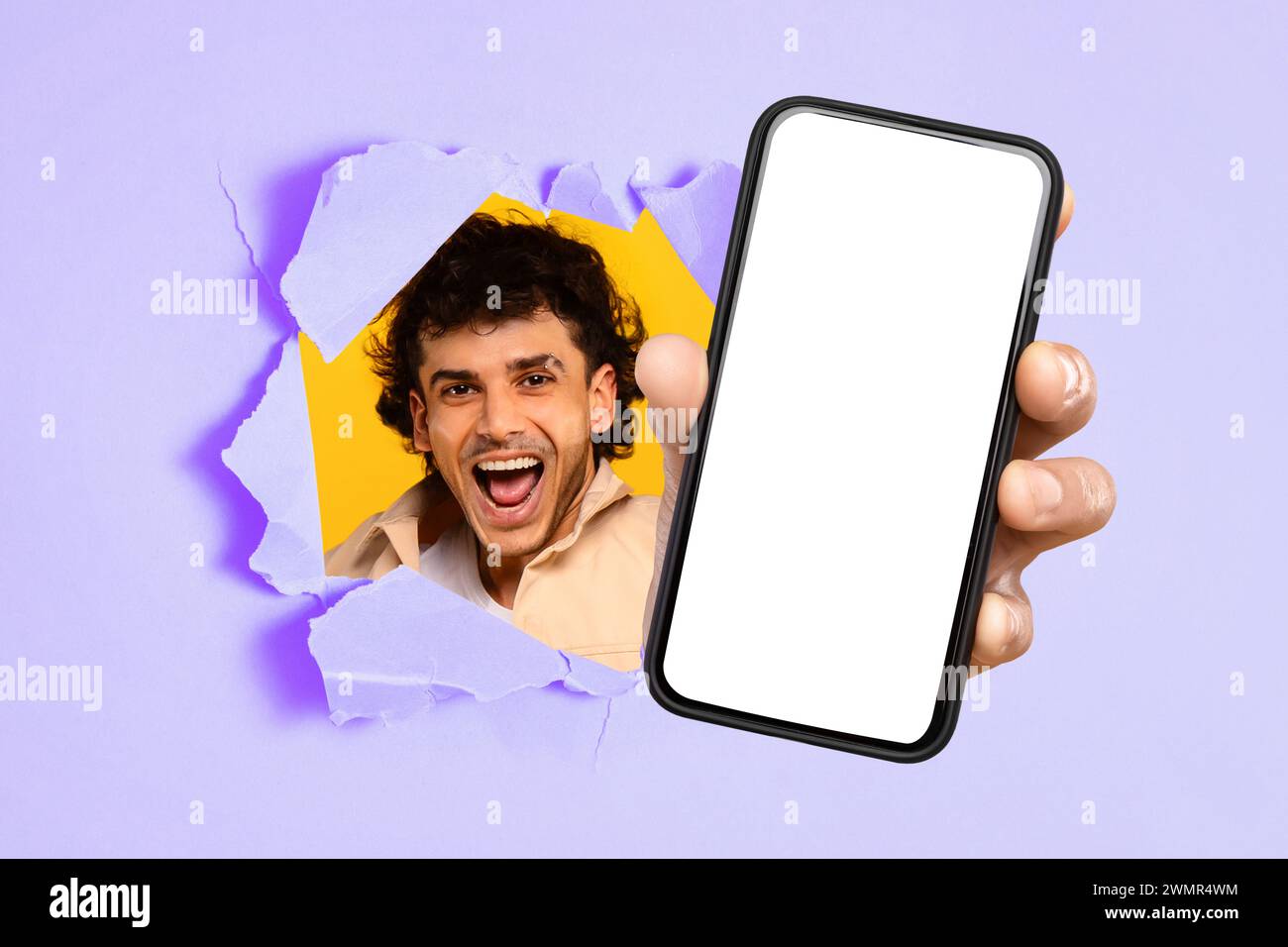 Exuberant young man with curly hair shouting with excitement as he ...