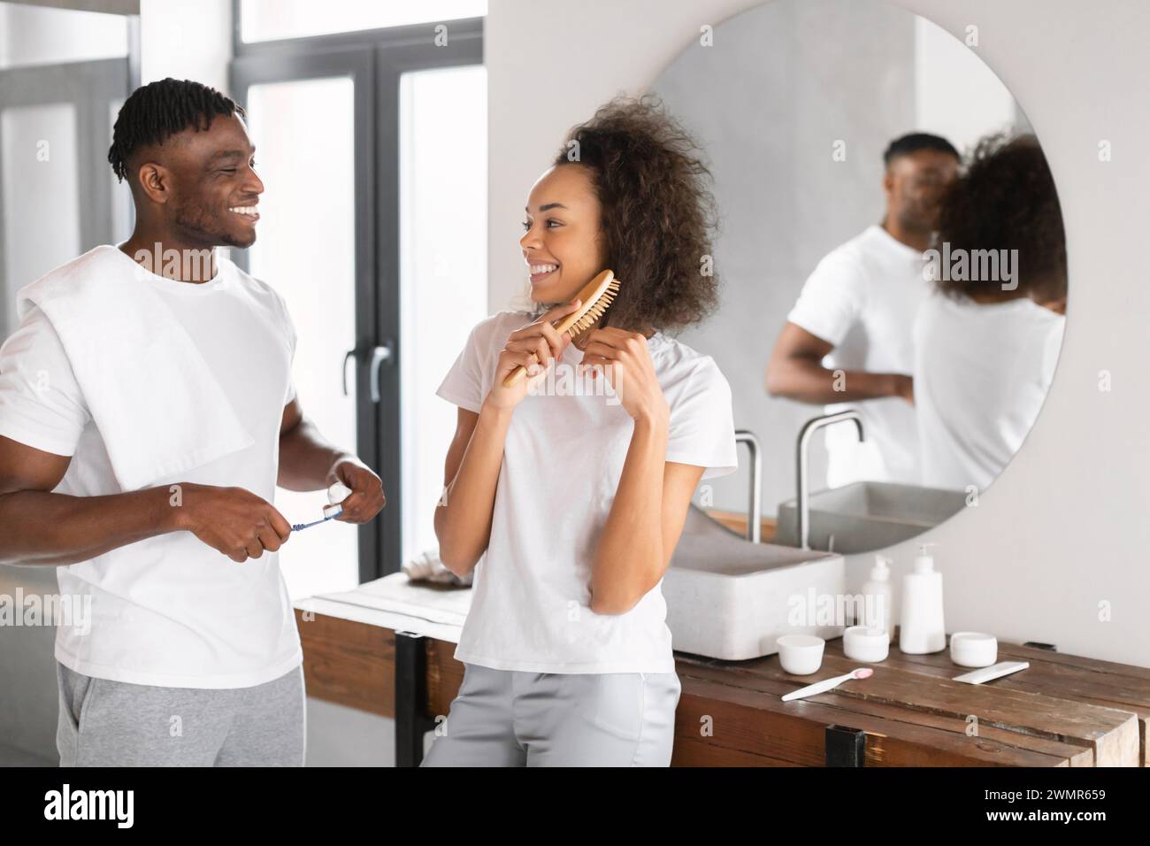 black couple leisurely getting ready together spending time in bathroom ...