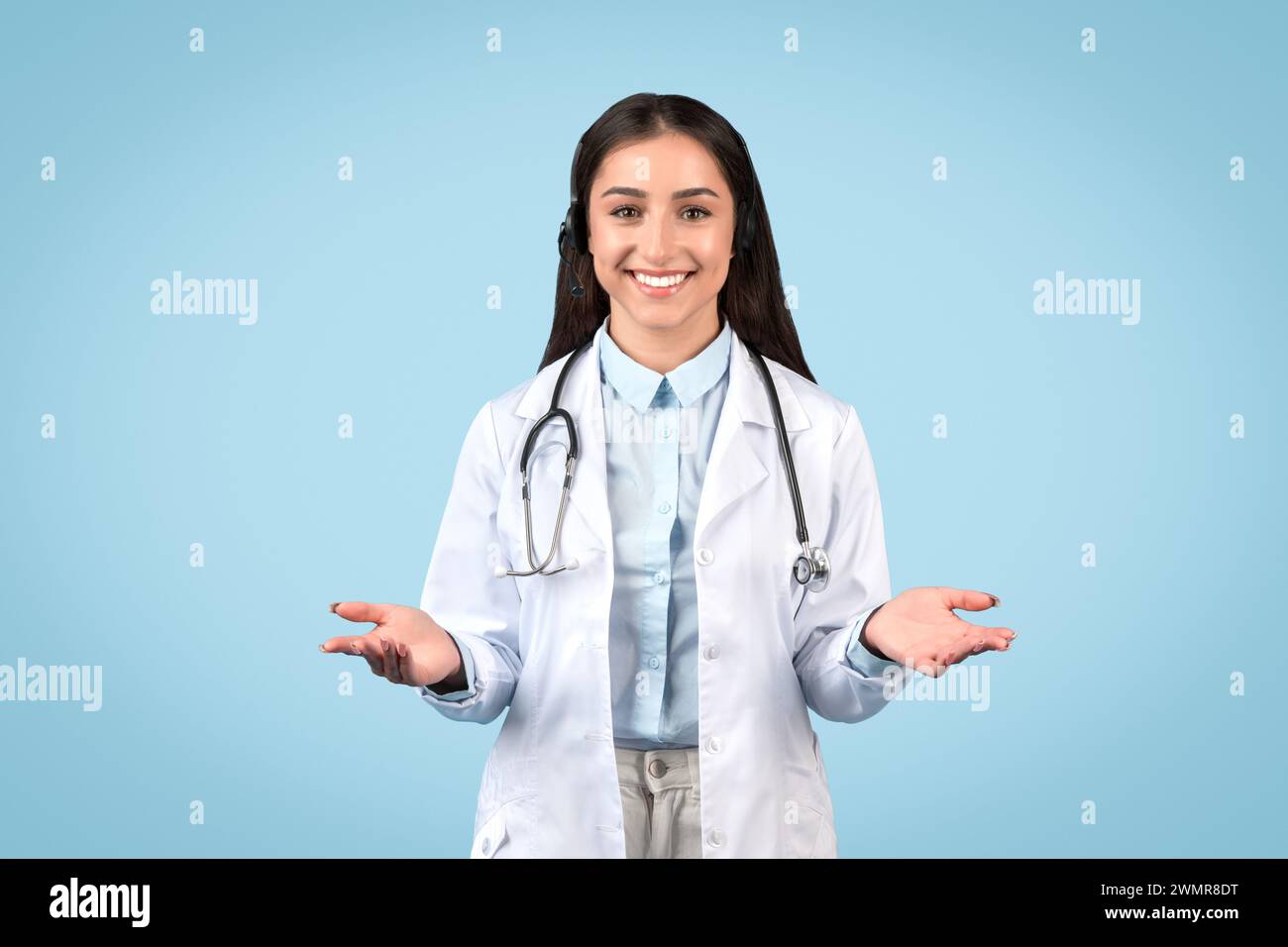 Inviting female doctor with open hands on blue background Stock Photo ...