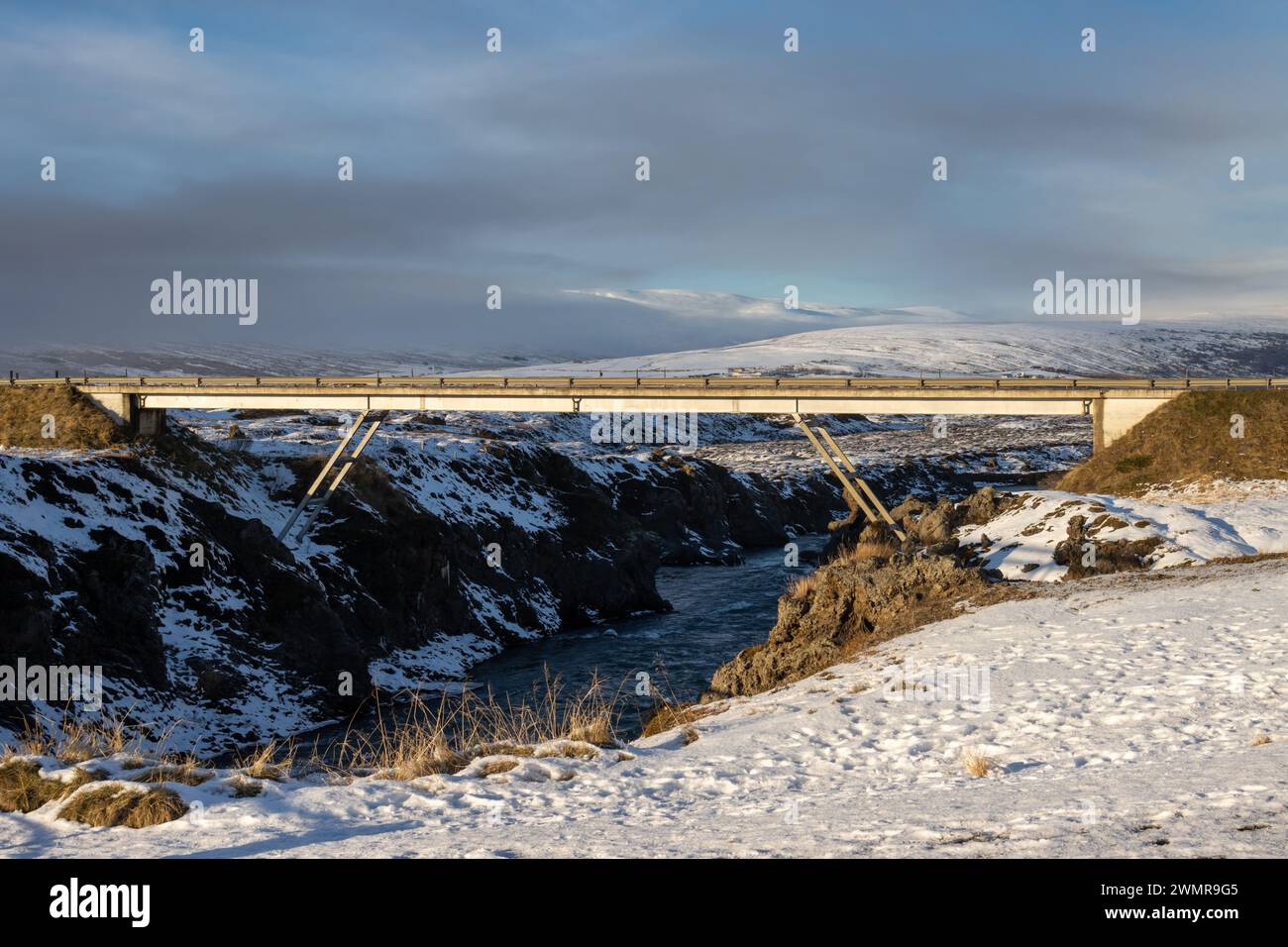 Country covered by a thin layer of an autumn snow. Bridge across a ...