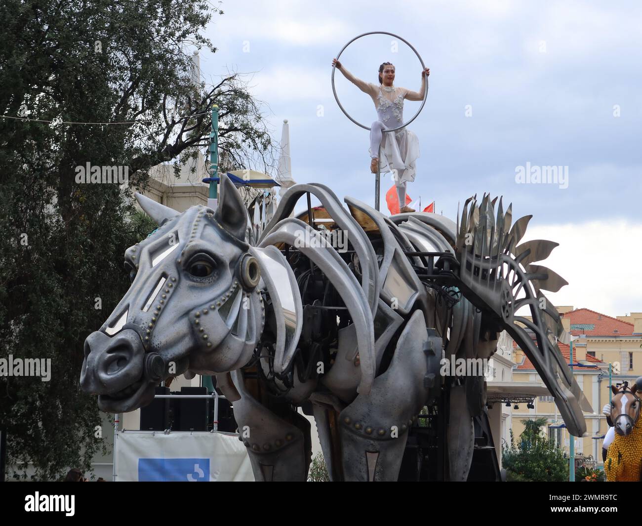 An acrobat performs high up on a giant animatronic horse on one of the ...