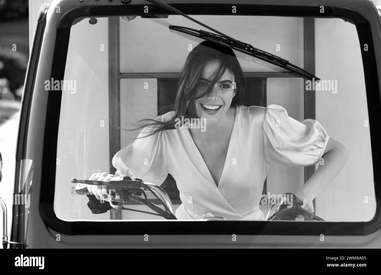 Smiling woman in funny car. Electric cars Stock Photo - Alamy