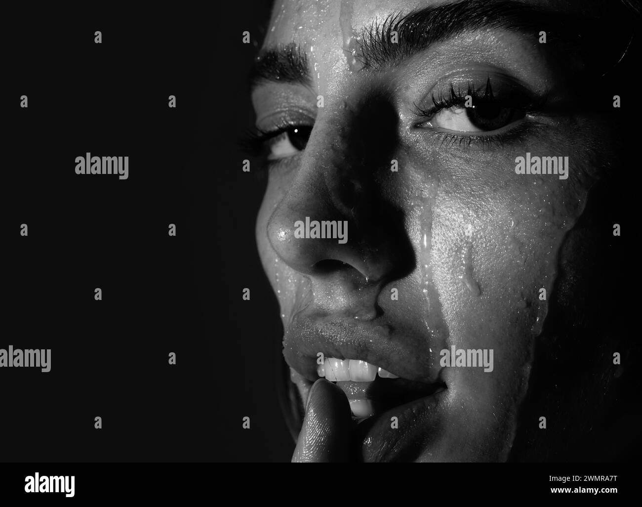 Beautiful young woman with honey on her face. Close up portrait of girl ...