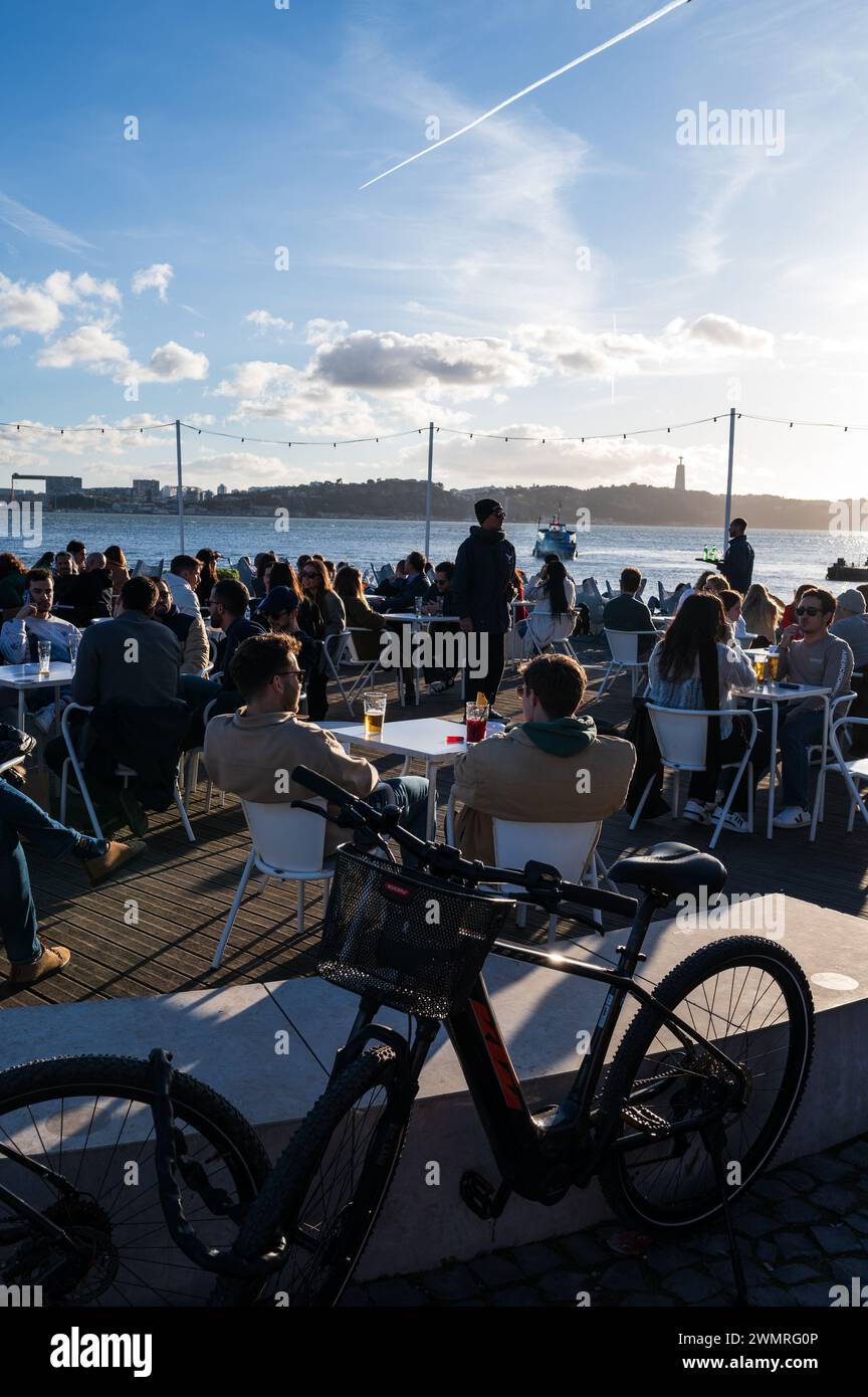 People enjoying Ribeira das Naus, the riverfront promenade and urban ...