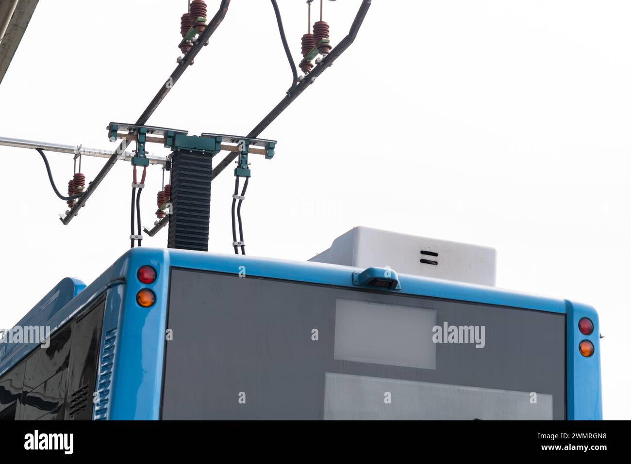 Electric bus at a stop is charged by pantograph. Clean mobility Stock ...
