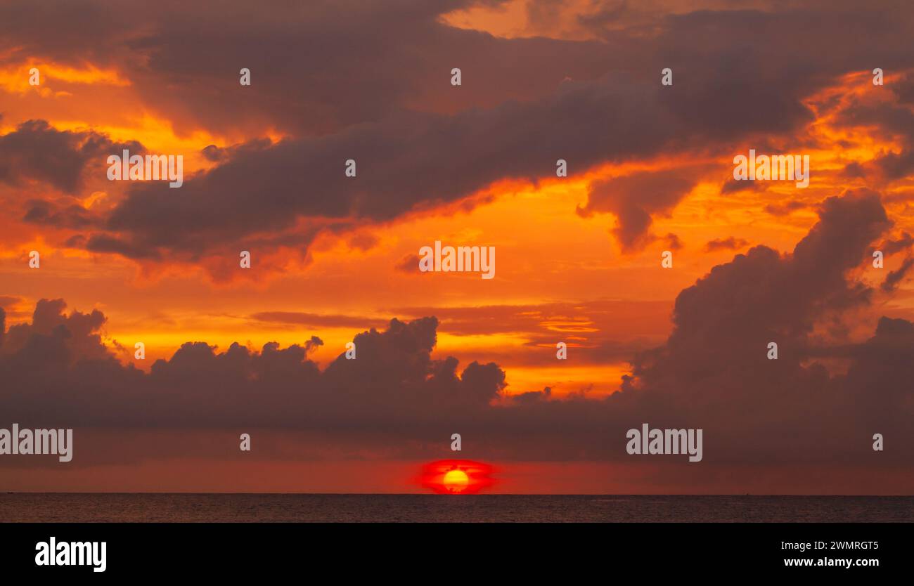 Coastal landscape with dramatic red sky over the ocean on a sunset ...