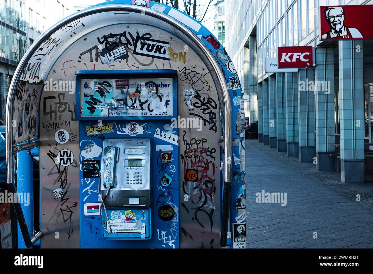 A telephone box covered in stickers and graffiti near Checkpoint ...