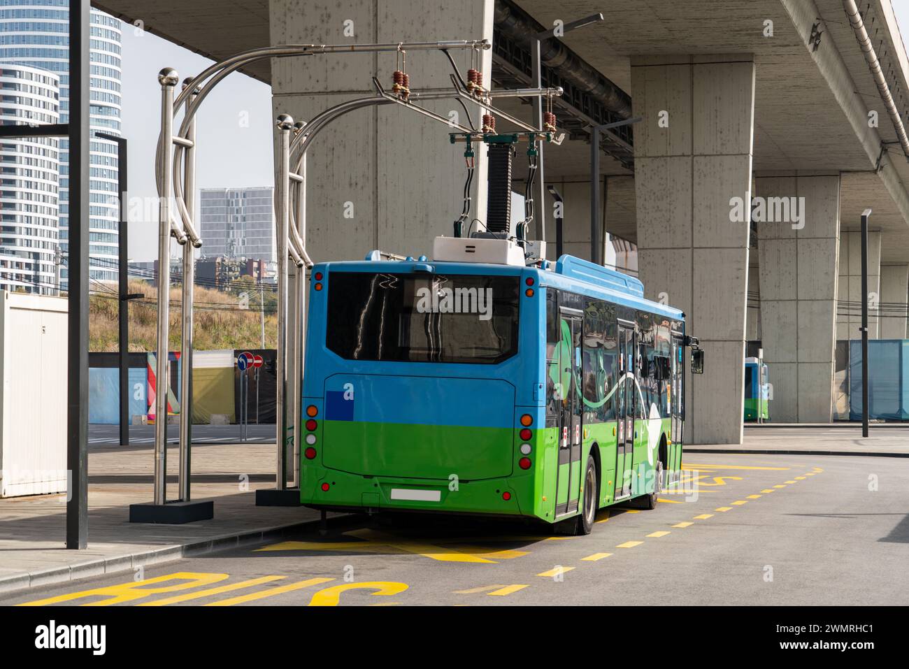 Electric bus at a stop is charged by pantograph. Clean mobility Stock ...